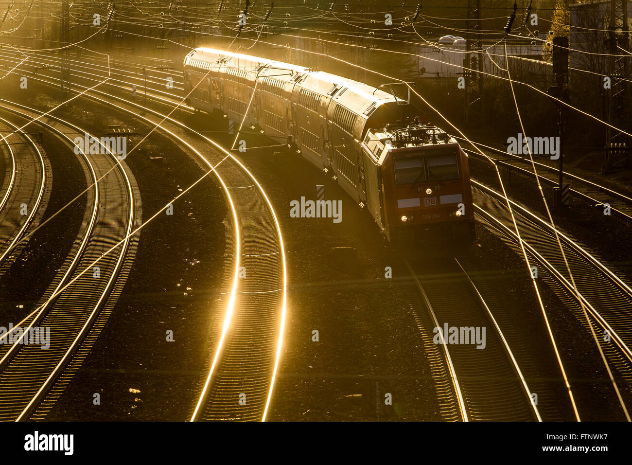 Railroad tracks, reflecting the sunlight, train on tracks Stock Photo ...