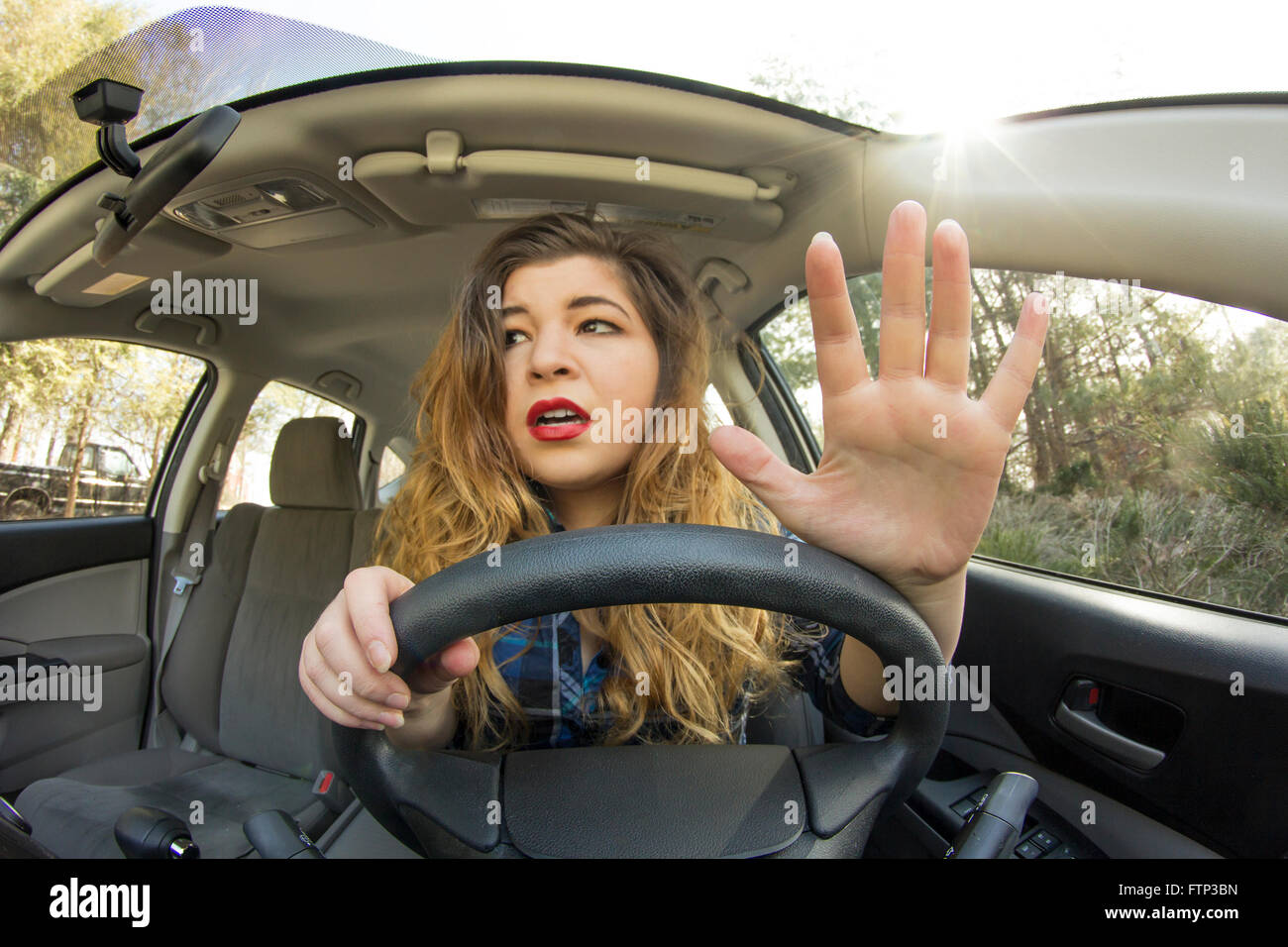 Silly girl gets into car crash and makes ridiculous face Stock Photo ...