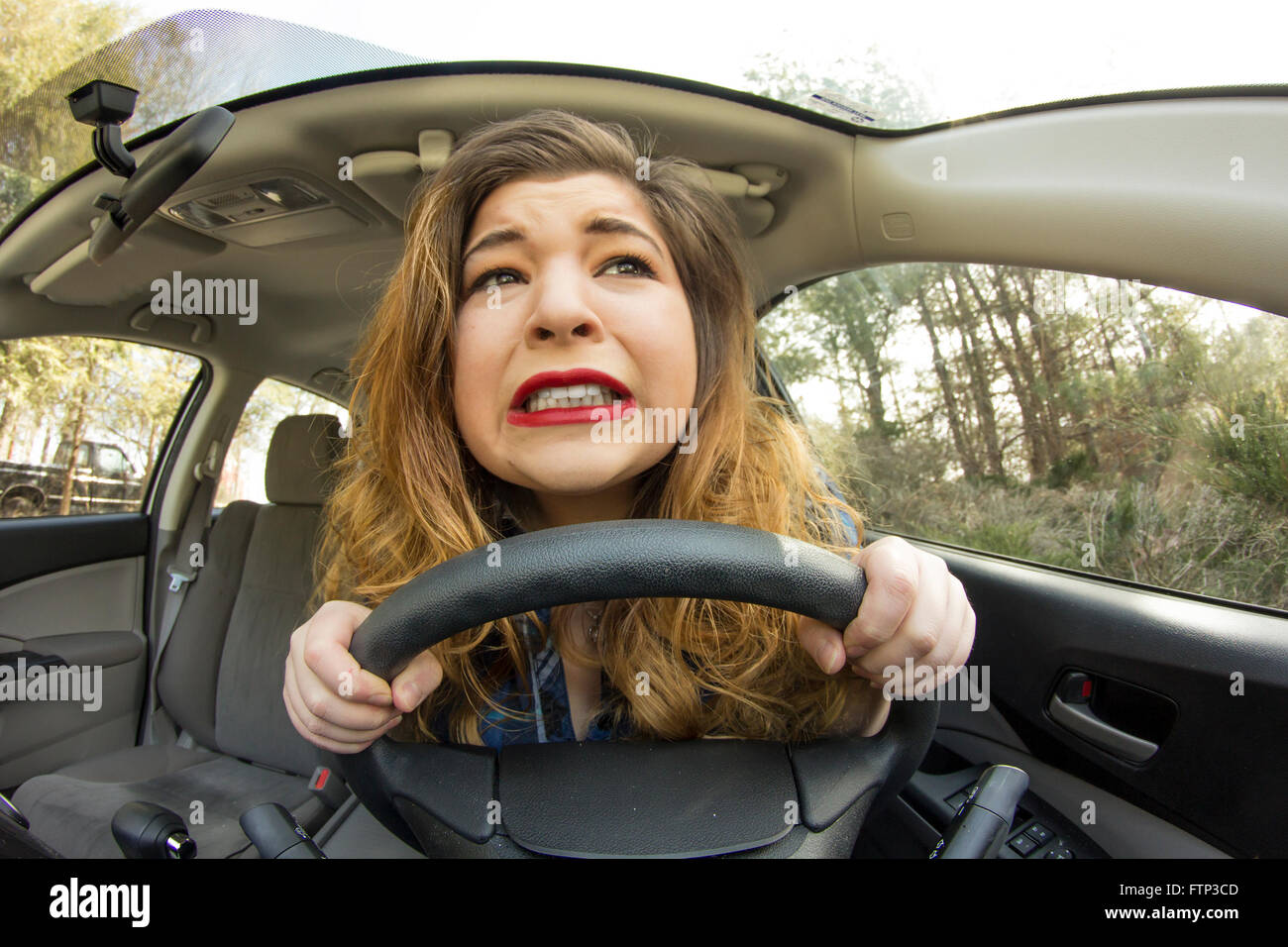 Silly girl gets into car crash and makes ridiculous face Stock Photo ...
