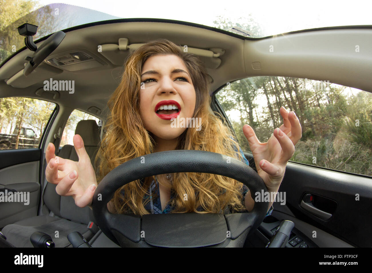 Silly girl gets into car crash and makes ridiculous face Stock Photo ...