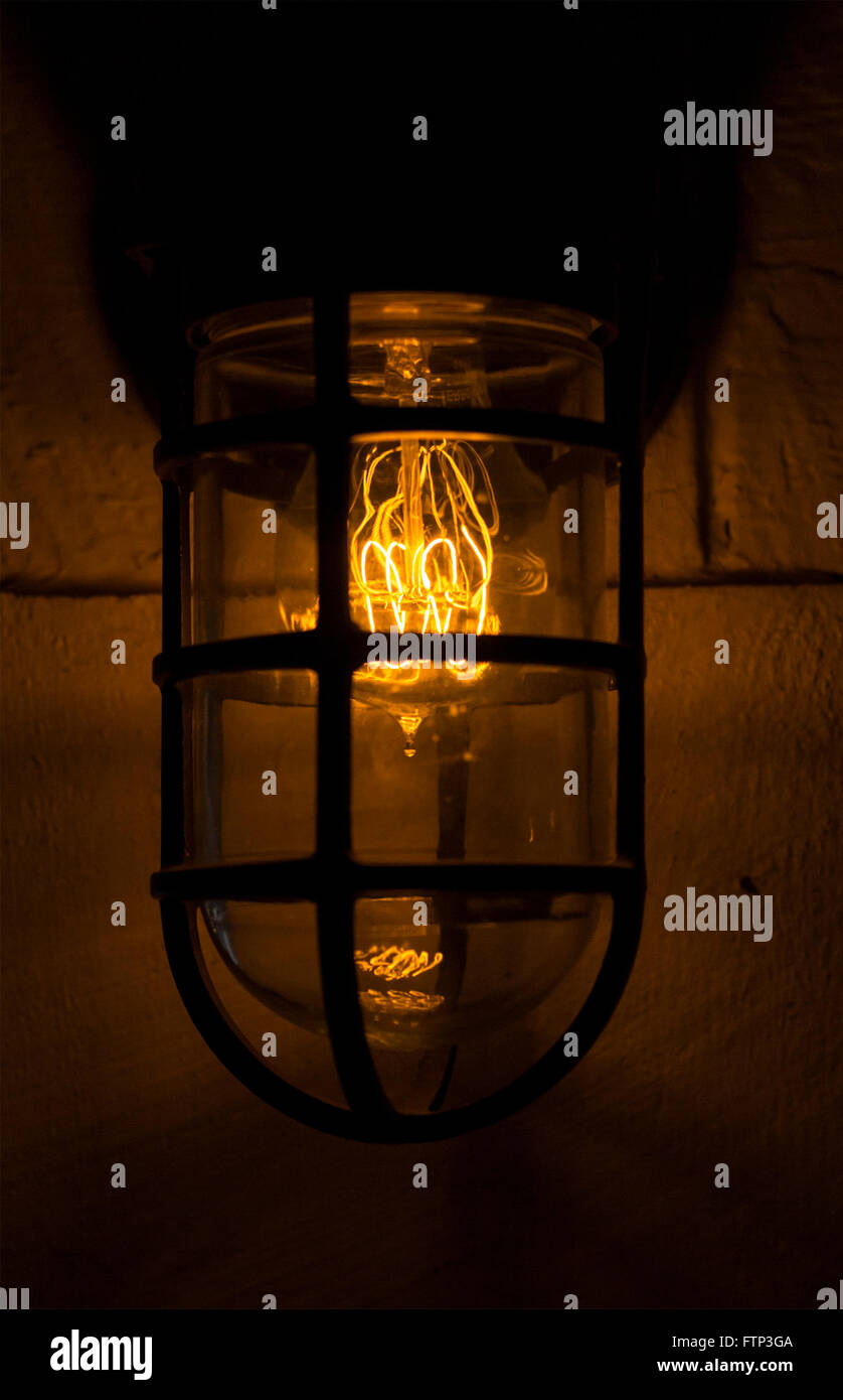 Decorative antique edison style filament light bulb outside at night ...