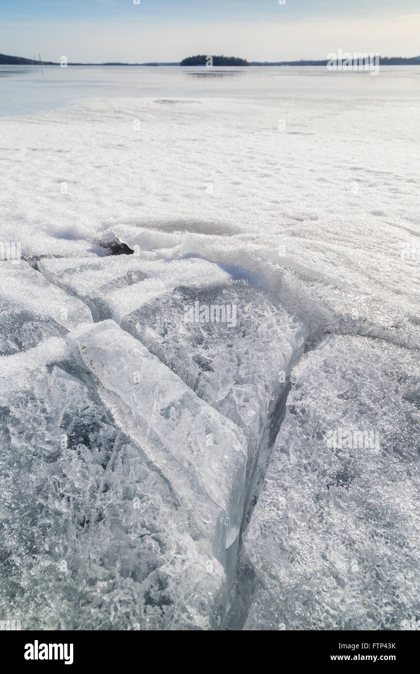 Beautiful and cracked ice at a frozen lake in Finland in the spring ...