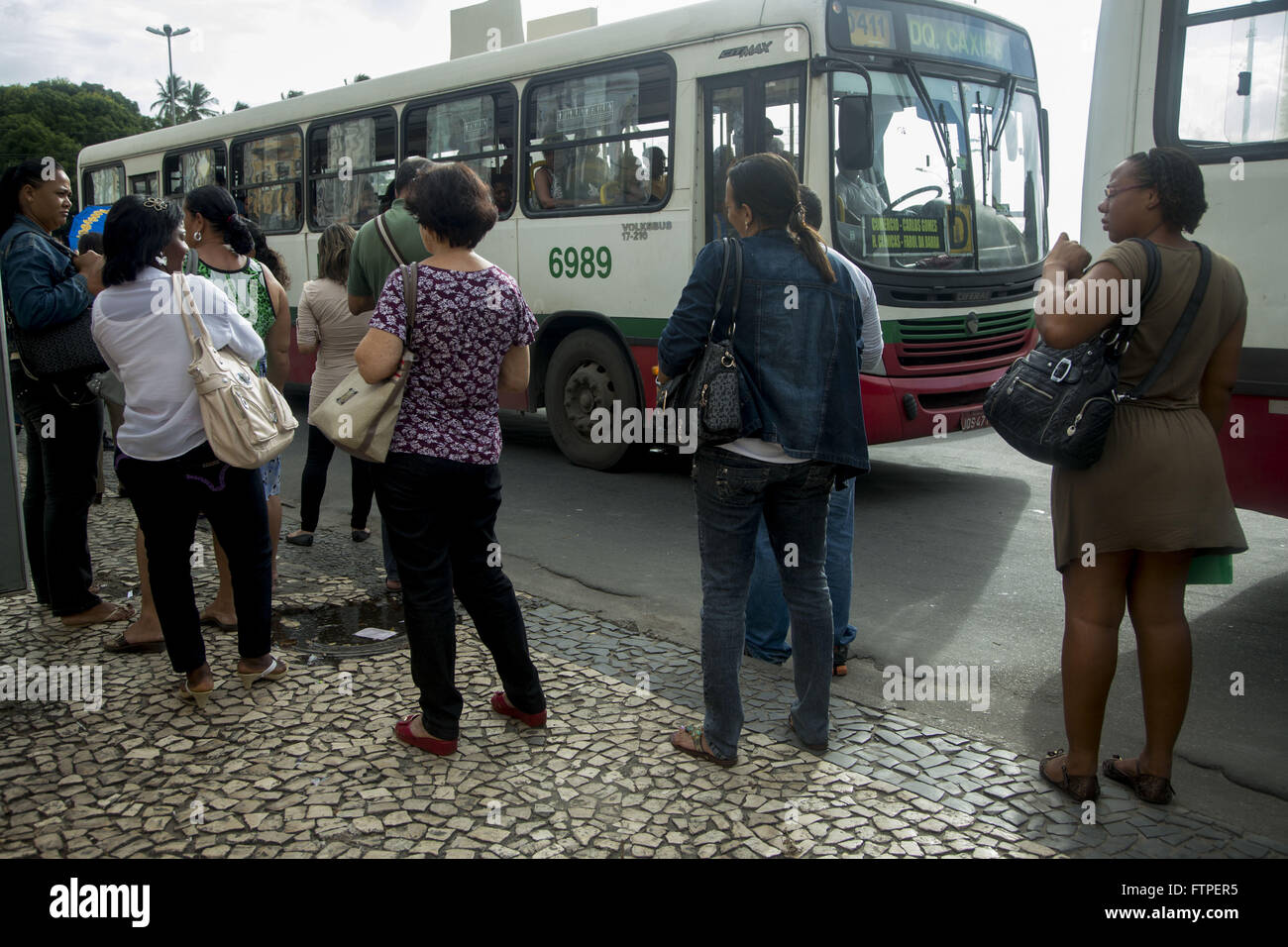 People at the bus stop in town Stock Photo - Alamy