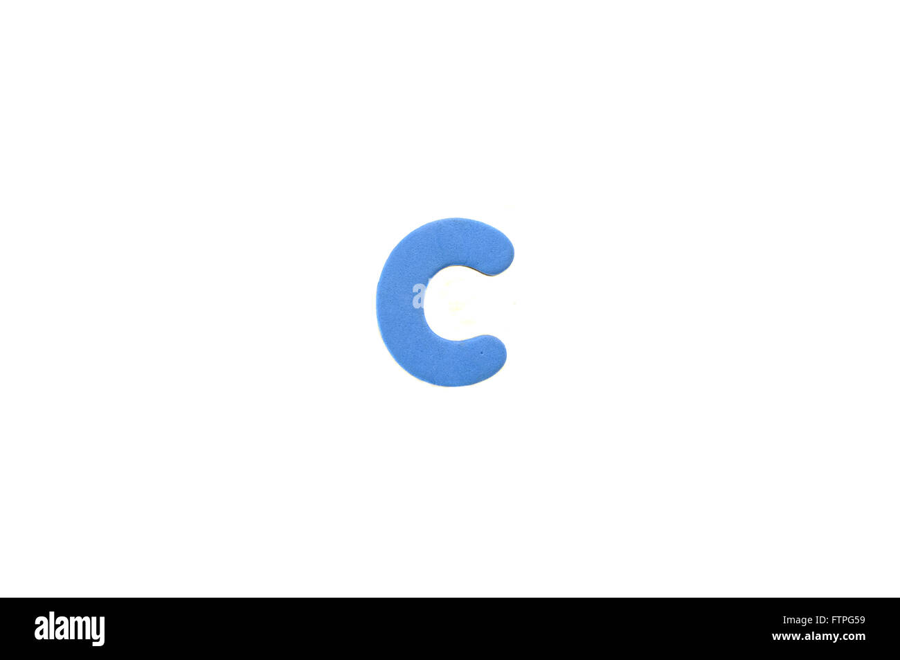 A letter C fridge magnet photographed against a white background Stock ...