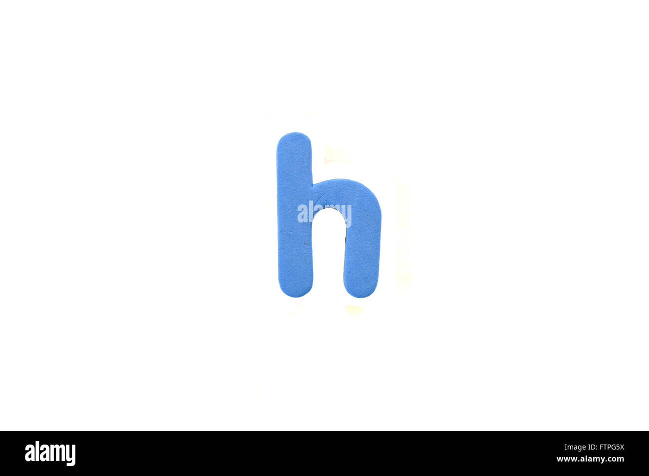 A letter H fridge magnet photographed against a white background Stock ...