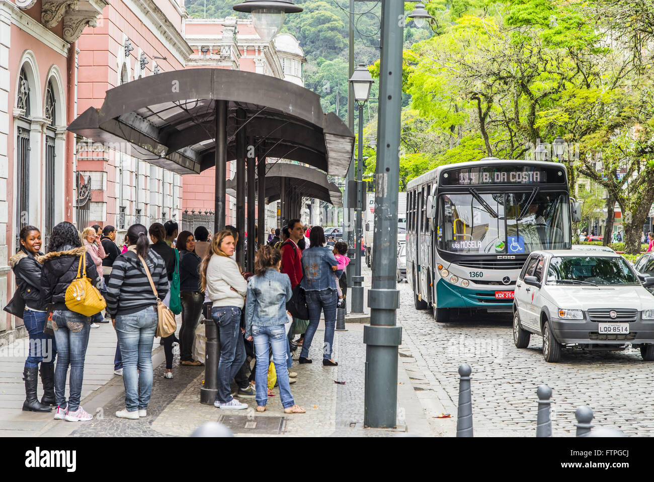 People at the bus stop in the street of the Emperor in the city center ...