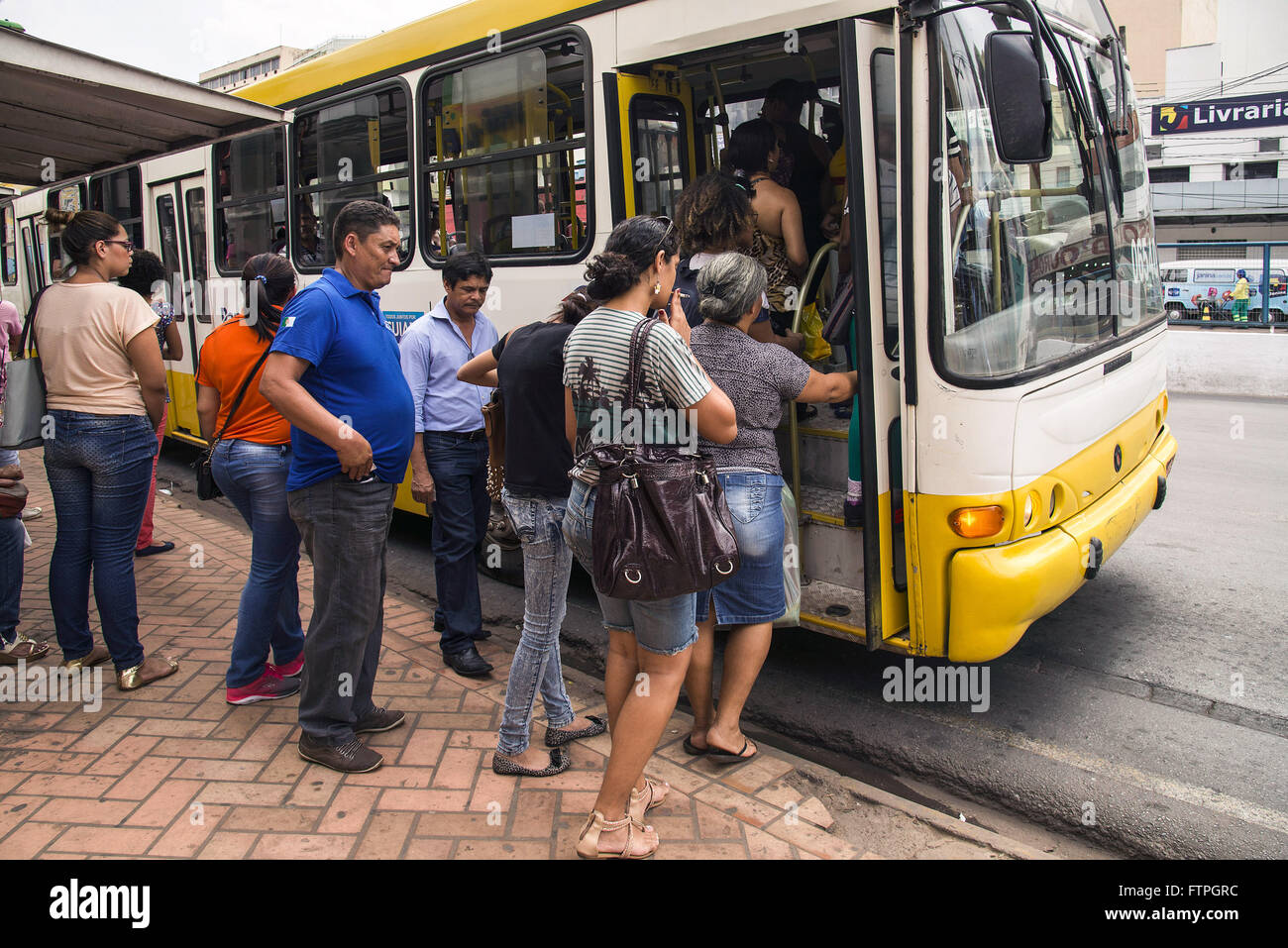 Passenger boarding the bus stop in the city center Stock Photo - Alamy