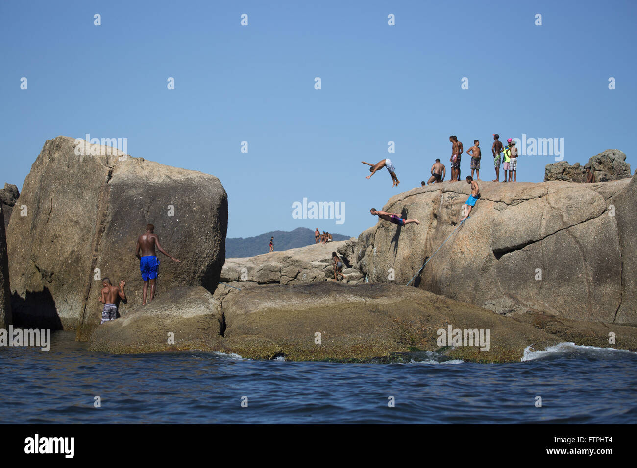 Diving into the sea from the rock formation Stock Photo - Alamy