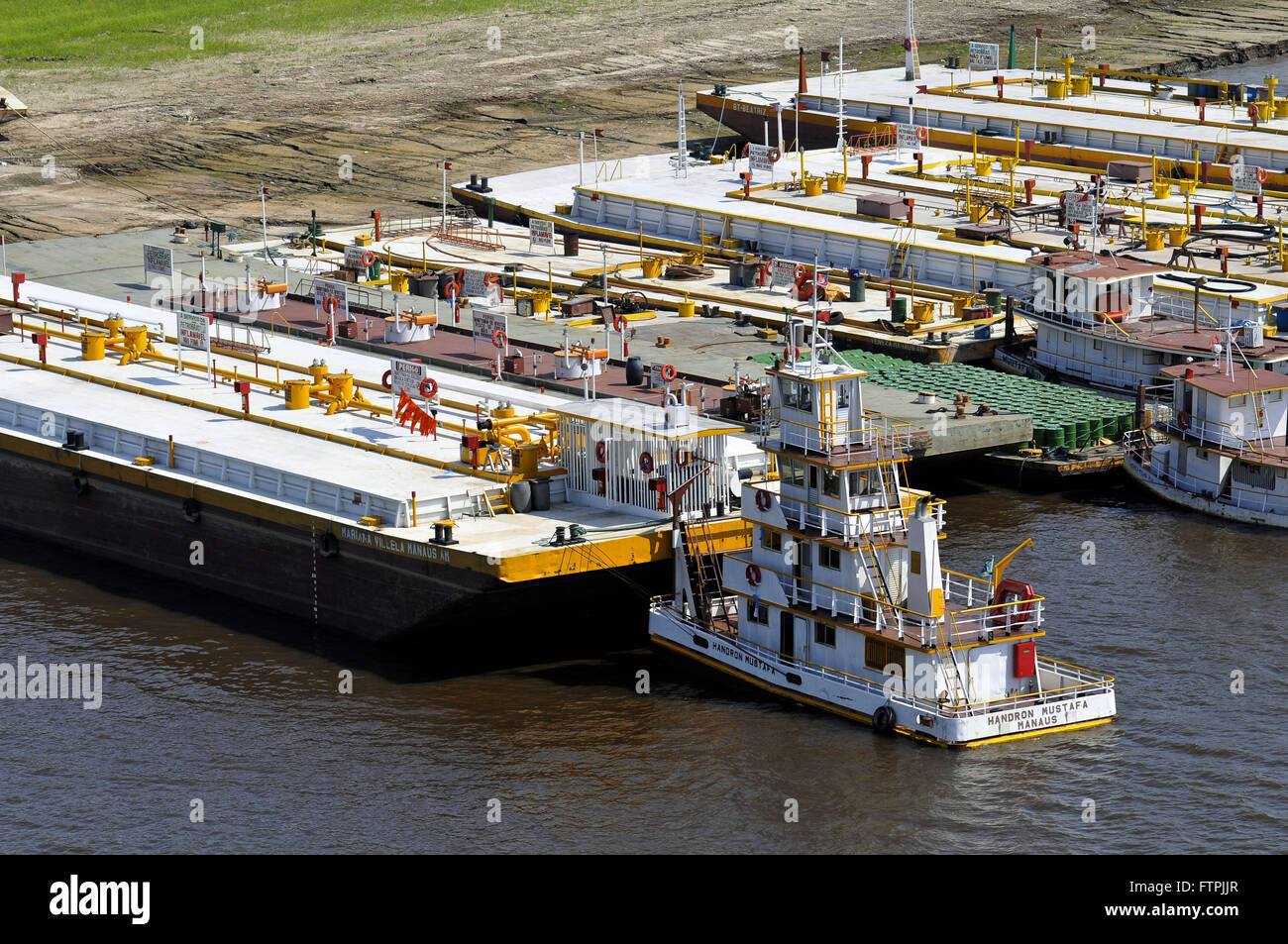 Barges transport fuel berth on the banks of the Rio Negro Stock Photo ...