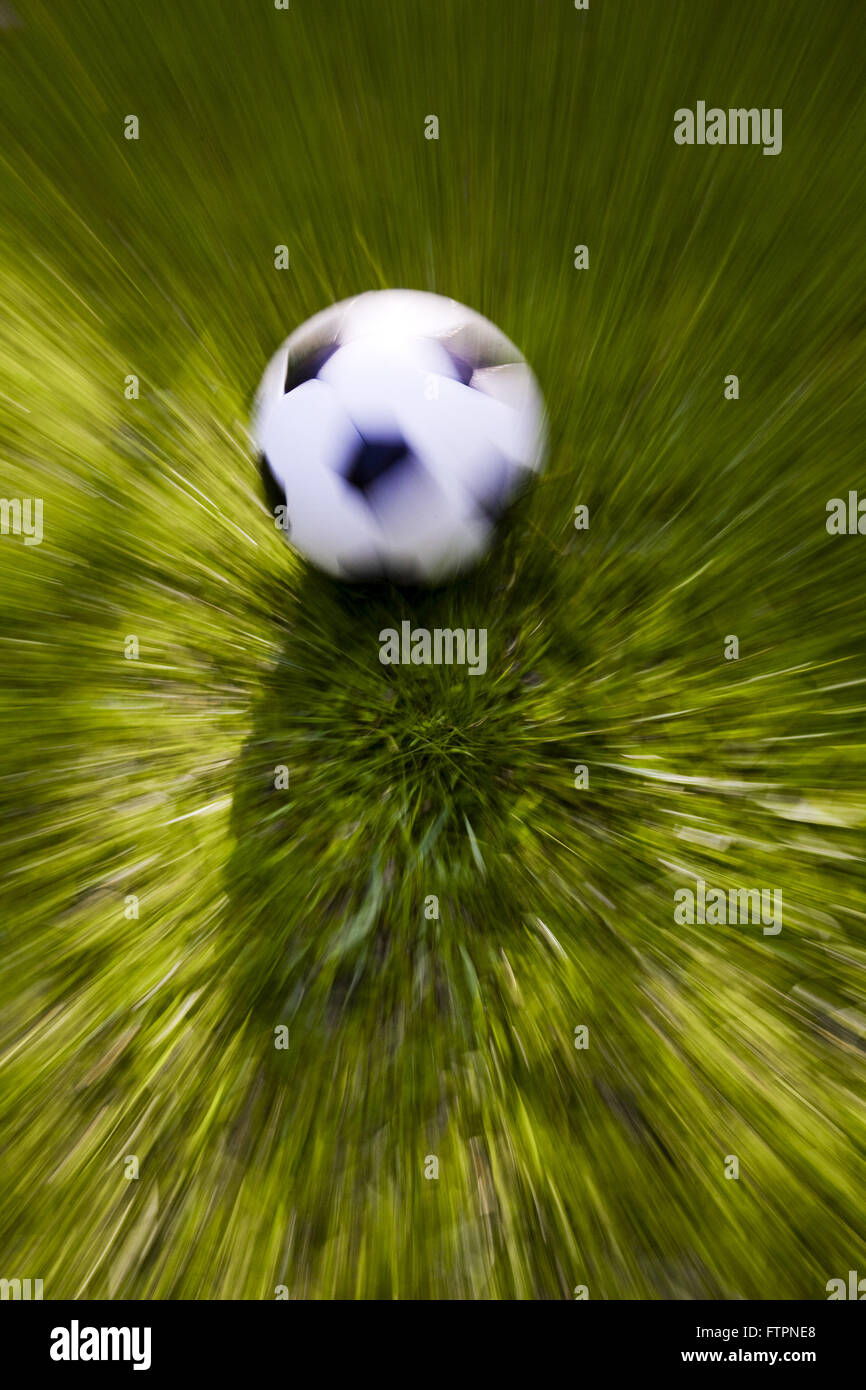 Soccer ball in motion on lawn Stock Photo - Alamy