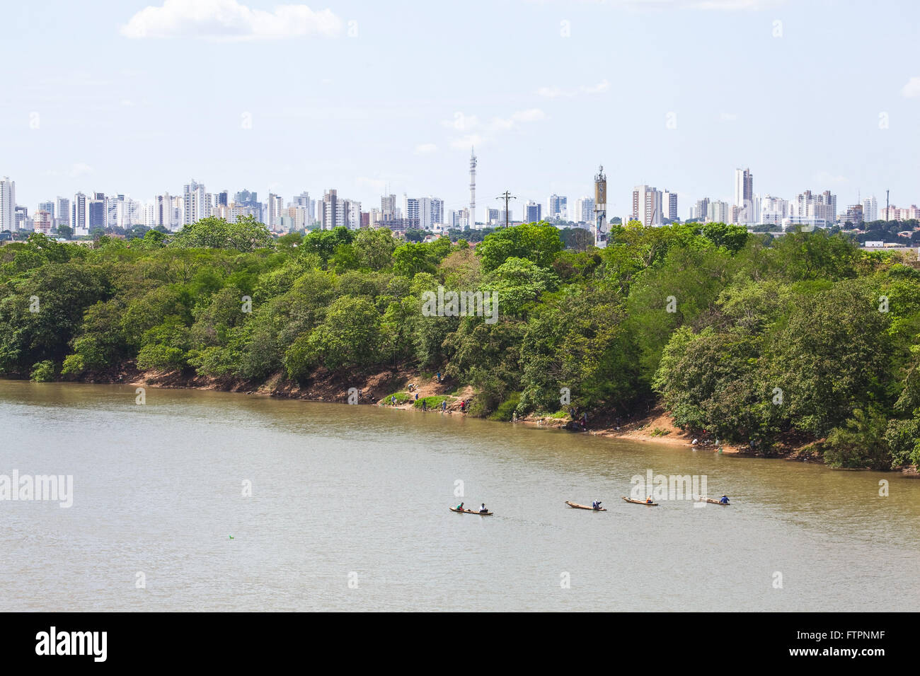 Fishermen in canoes on the Rio Cuiaba with city in the background Stock ...