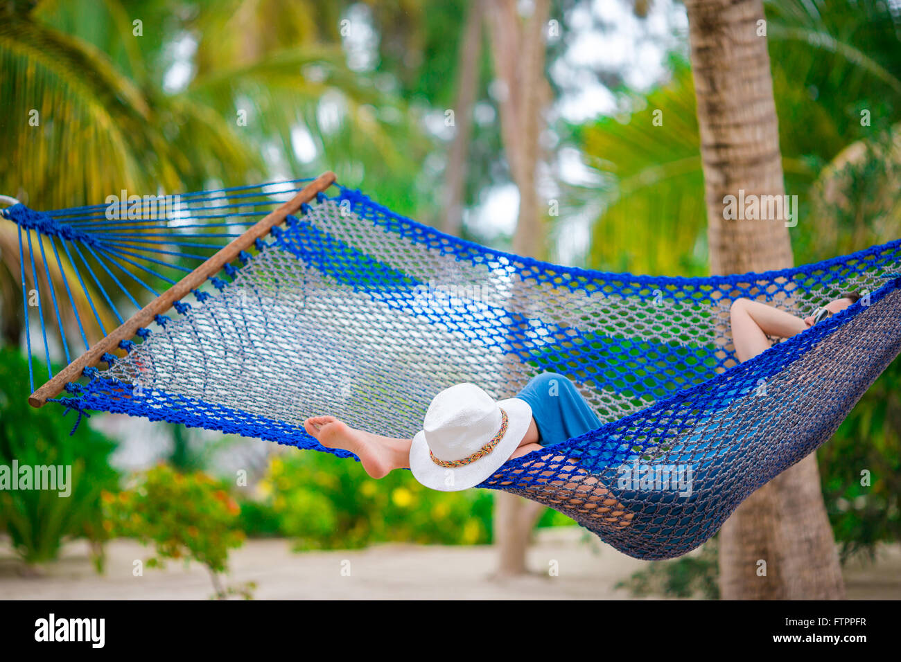 Beautiful woman relaxing at hammock on tropical beach Stock Photo - Alamy