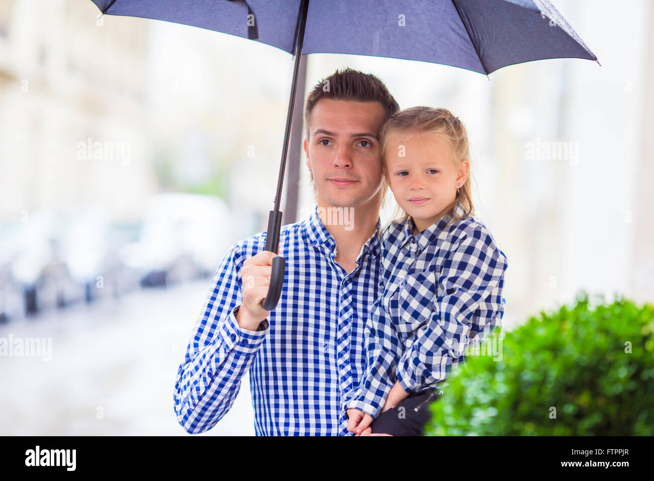 Family outdoors under rain in Paris, France Stock Photo - Alamy