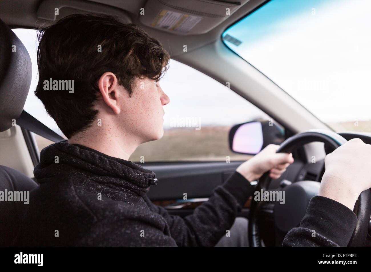 Teenage boy learning to drive on interstate highway Stock Photo - Alamy