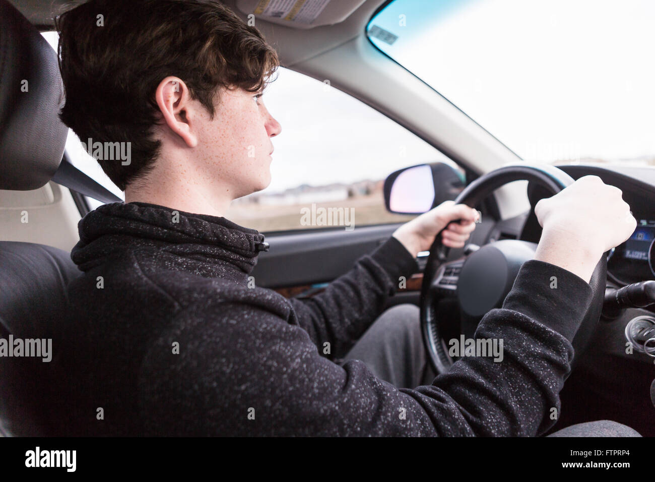 Teenage boy learning to drive on interstate highway Stock Photo - Alamy