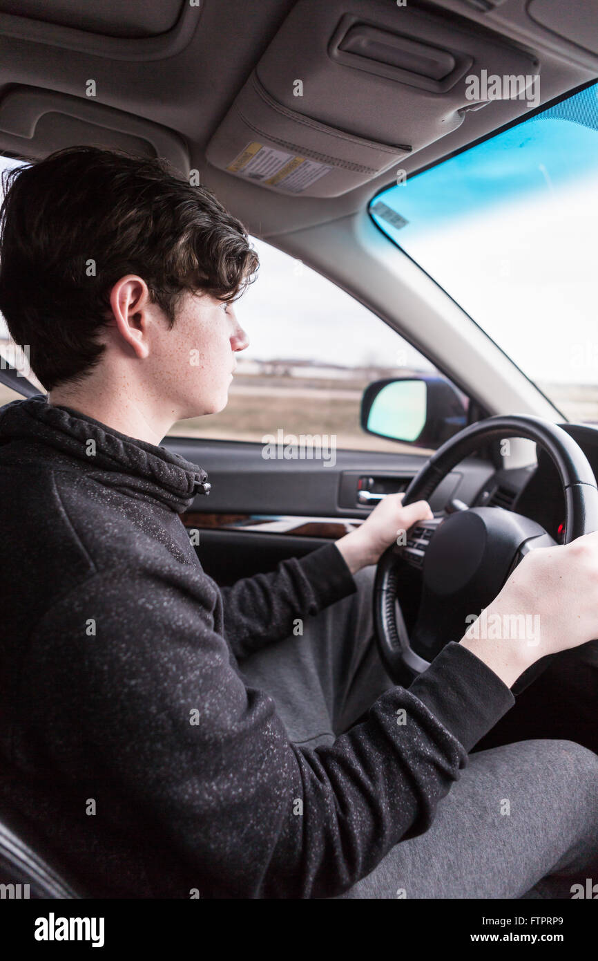 Teenage boy learning to drive on interstate highway Stock Photo - Alamy