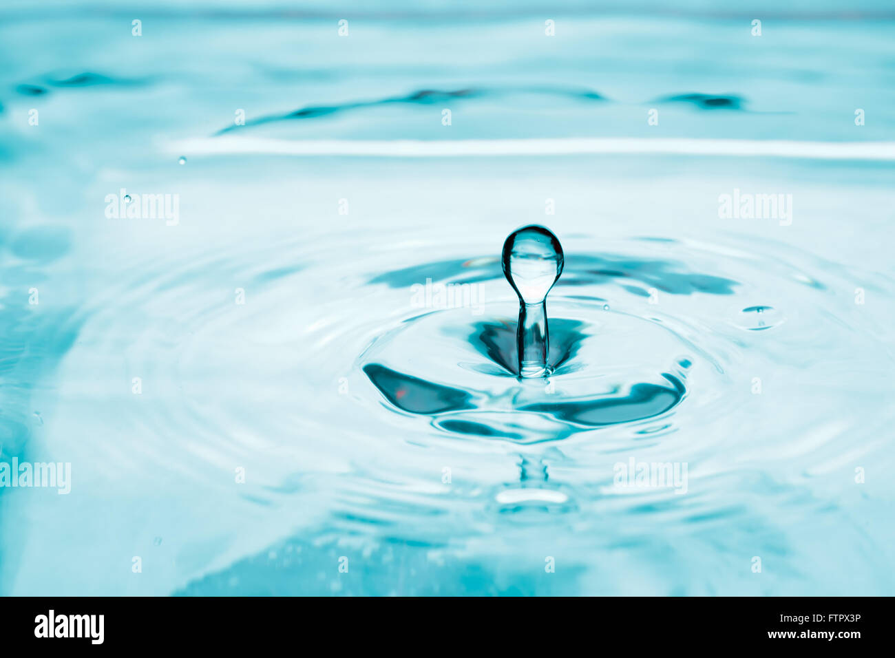 Beautiful colorful water splash from fallen drop Stock Photo - Alamy