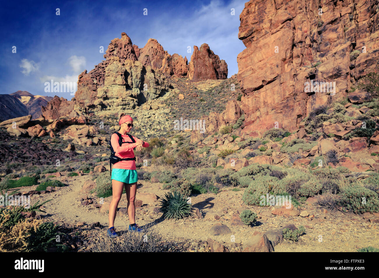 Runner training and checking stopwatch smart watch, cross country ...
