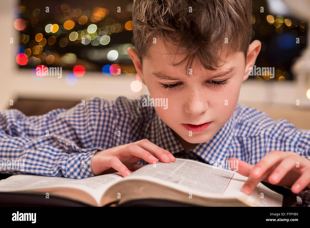 Child reading a thick book Stock Photo - Alamy