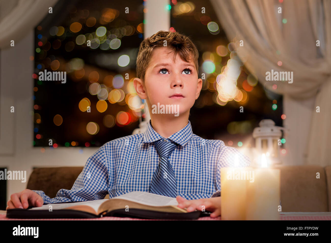 Child with book looking up Stock Photo - Alamy