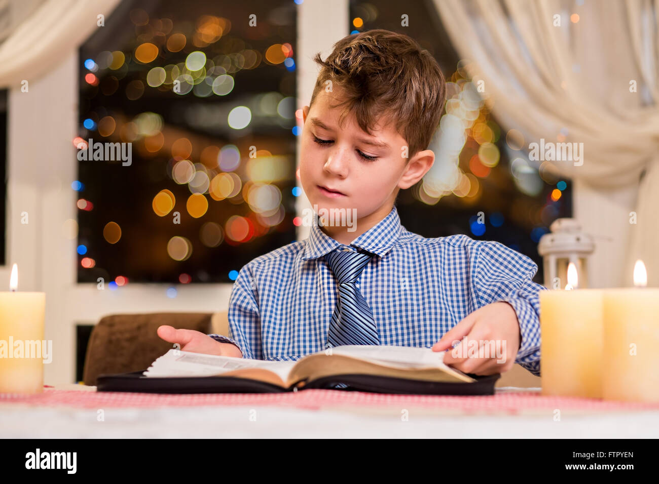 Young kid turns book page Stock Photo - Alamy