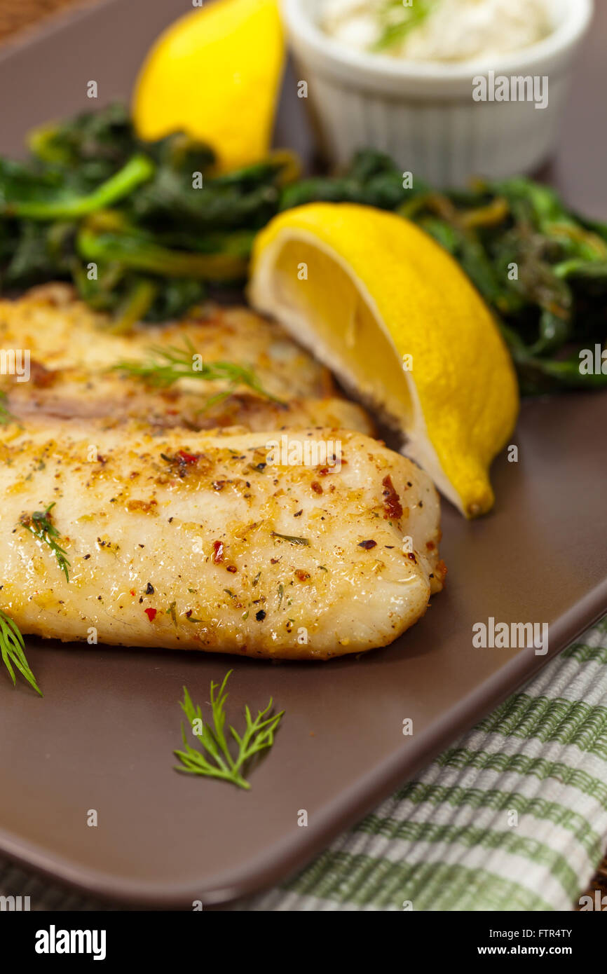 Baked Fish Fillet with Sauteed Spinach Stock Photo - Alamy
