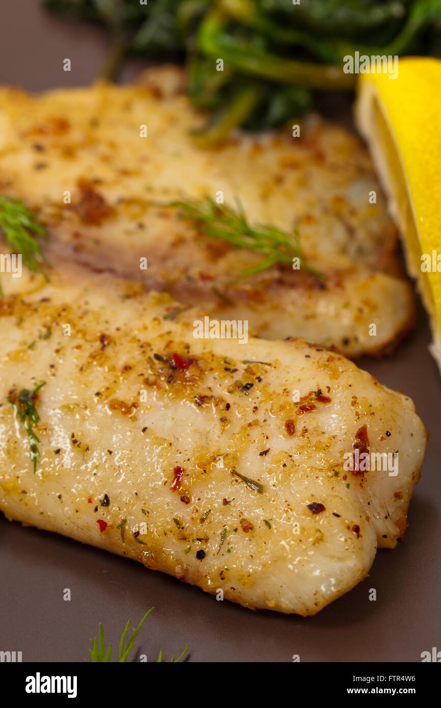 Baked Fish Fillet with Sauteed Spinach Stock Photo - Alamy