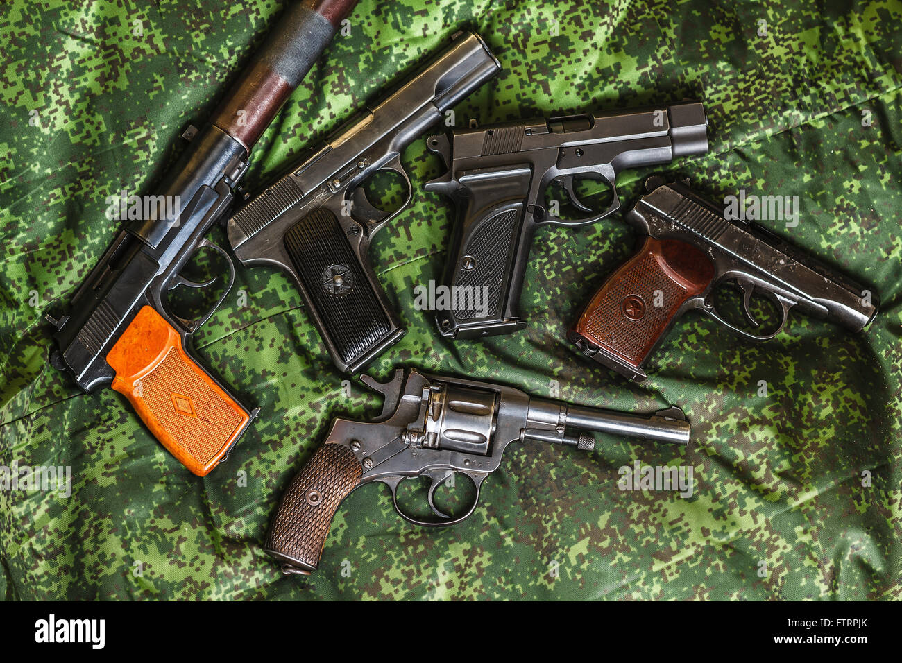 semi-automatic pistols on pixel camouflage background Stock Photo - Alamy
