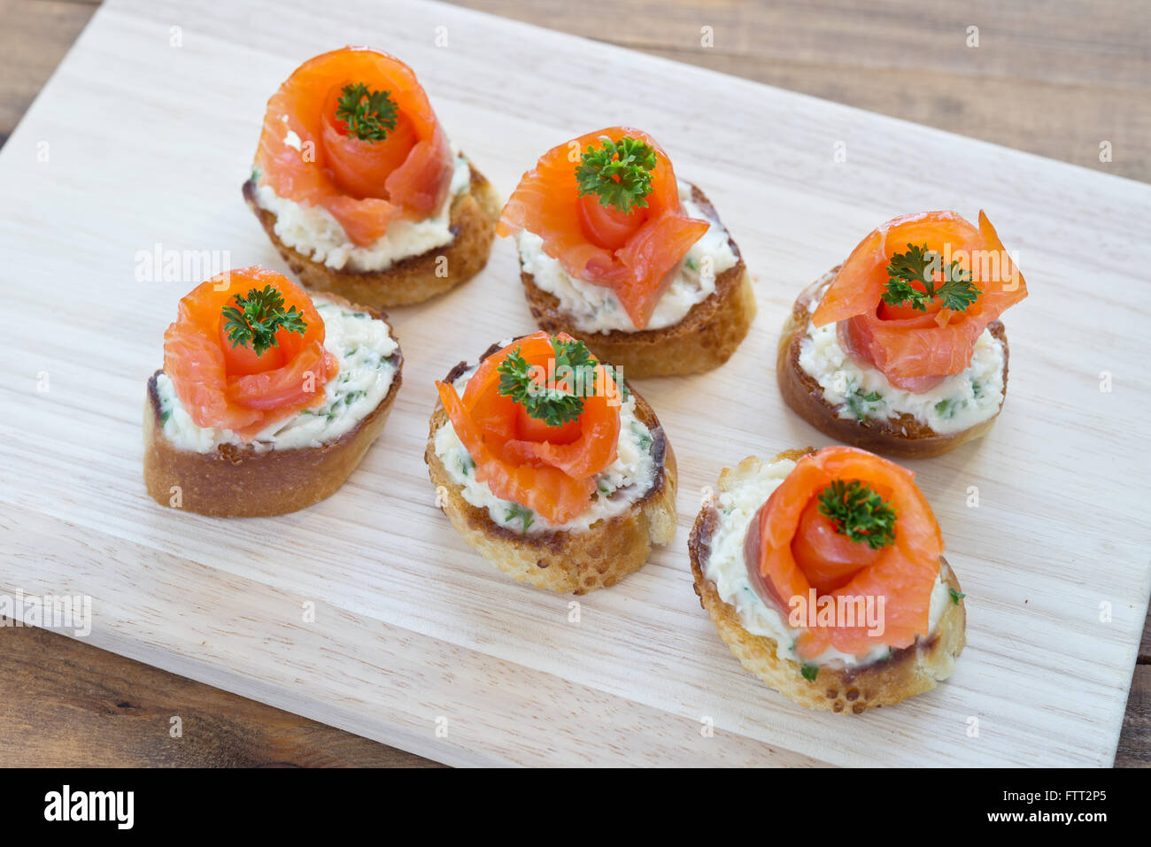 canapes with salmon and cheese on wooden board Stock Photo - Alamy