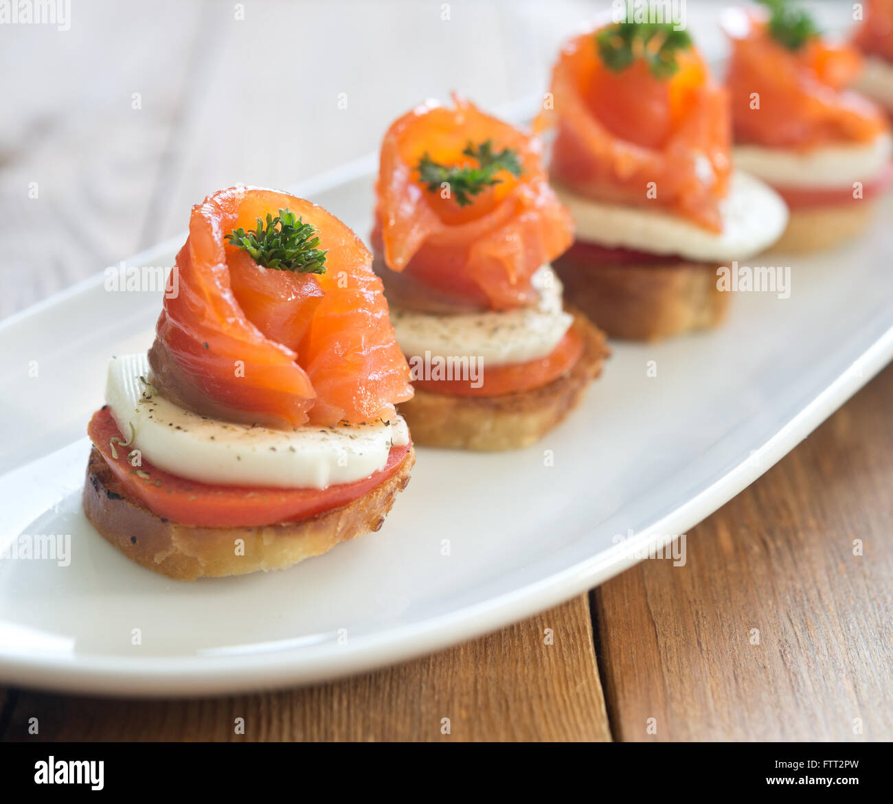 canapes with salmon and cheese on wooden board Stock Photo - Alamy