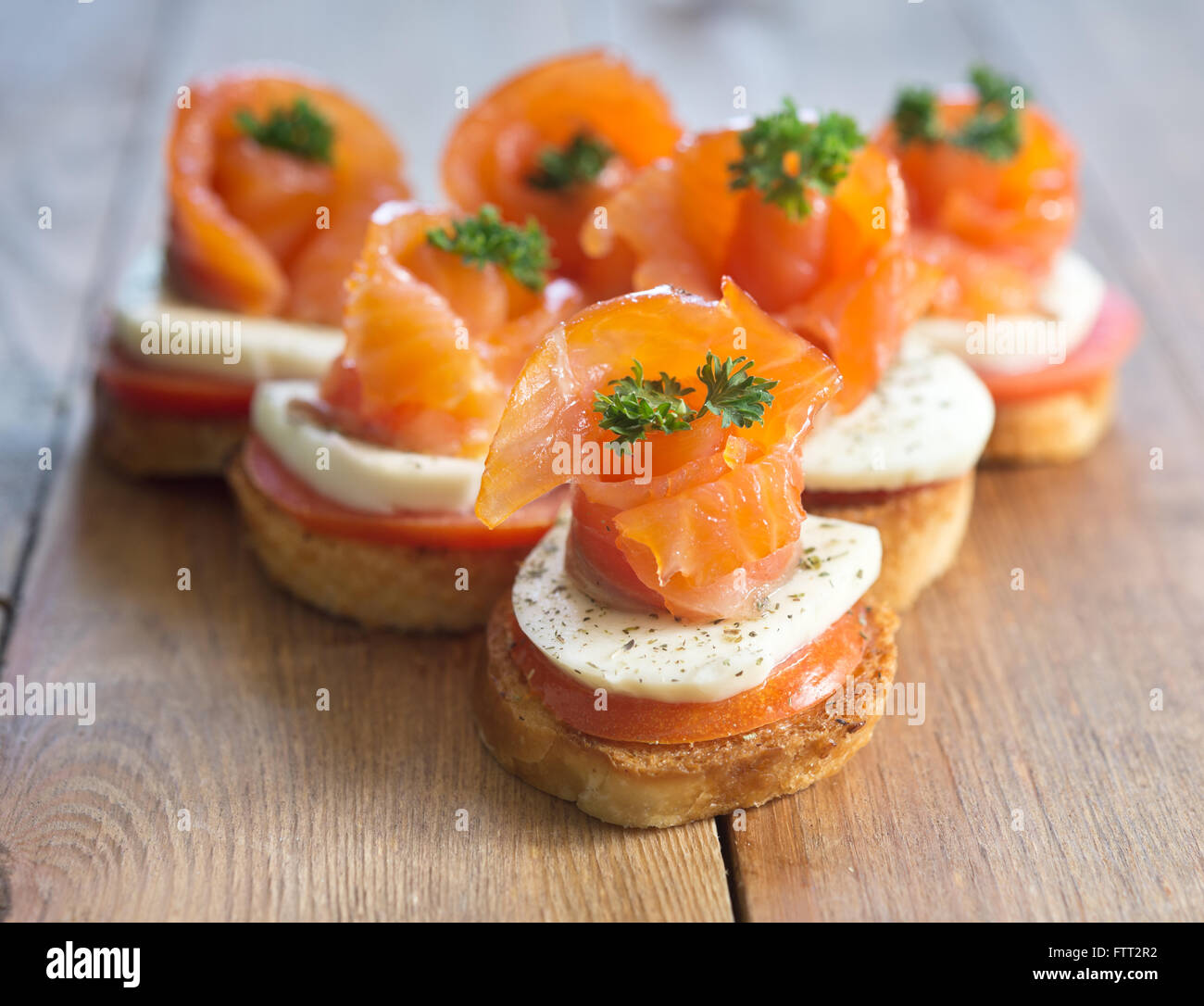 canapes with smoked salmon on wooden table Stock Photo - Alamy