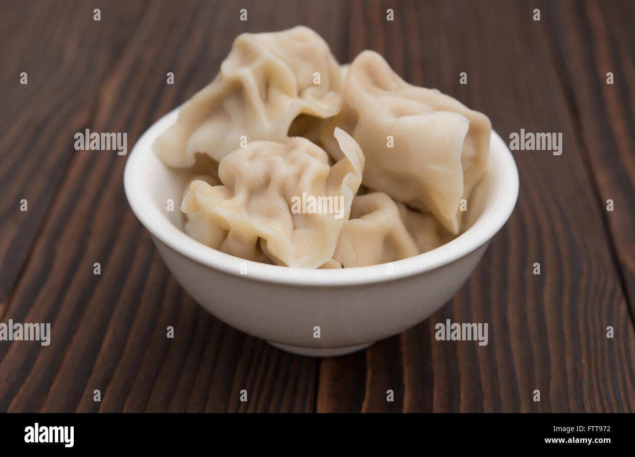 bowl full of dumpling on wooden background Stock Photo - Alamy