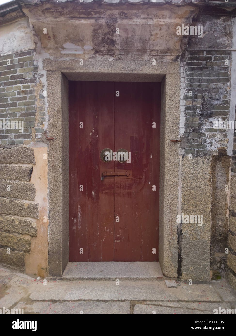 ancient wooden gate surrounded by stones and bricks Stock Photo - Alamy