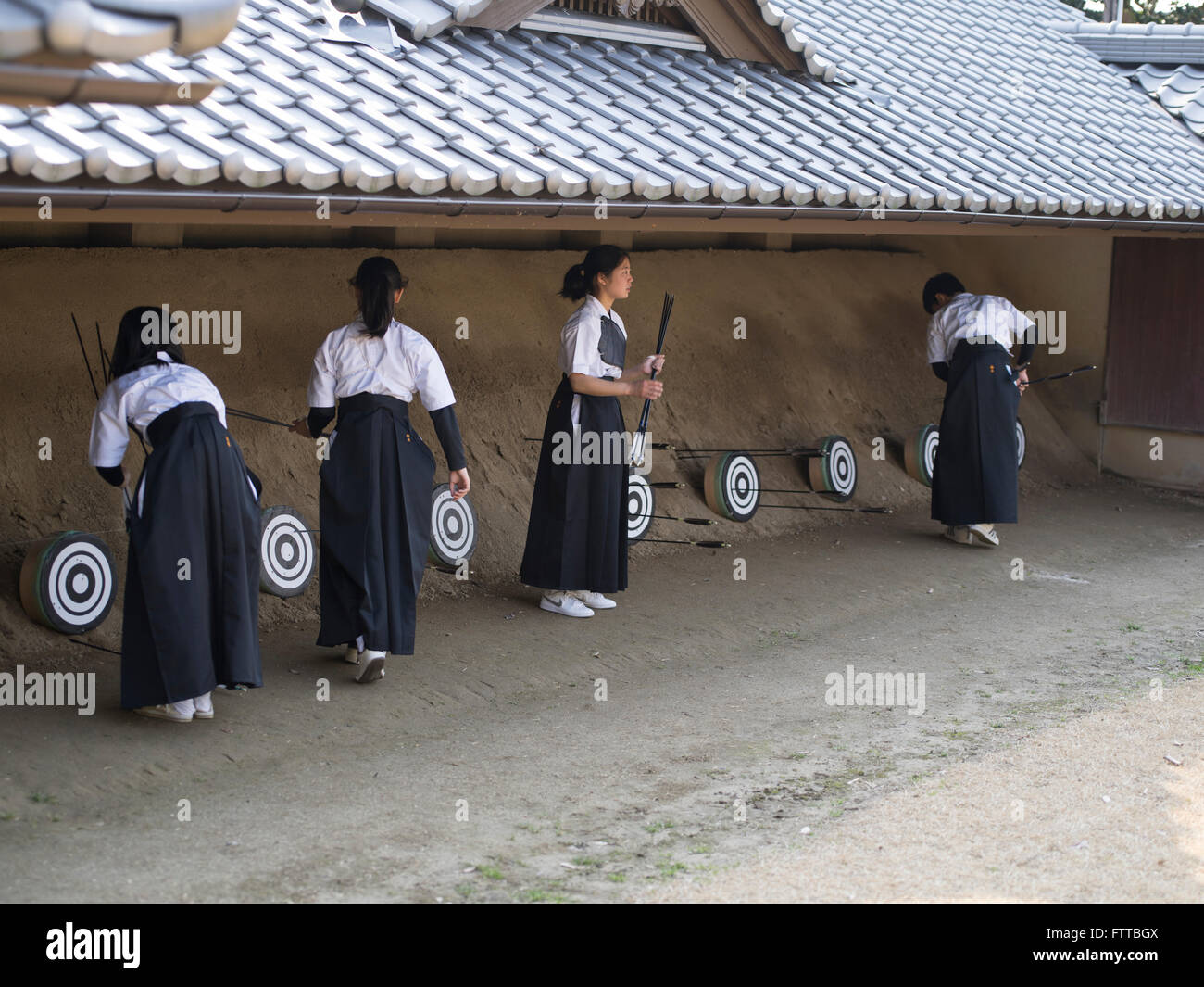 Young students practice kyudo Japanese archery at Kibitsu Shrine ...