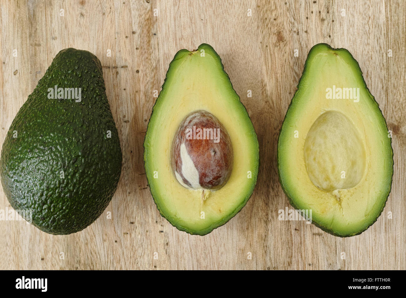 Fresh avocado with avocado leaves on teak wood table top Stock Photo ...