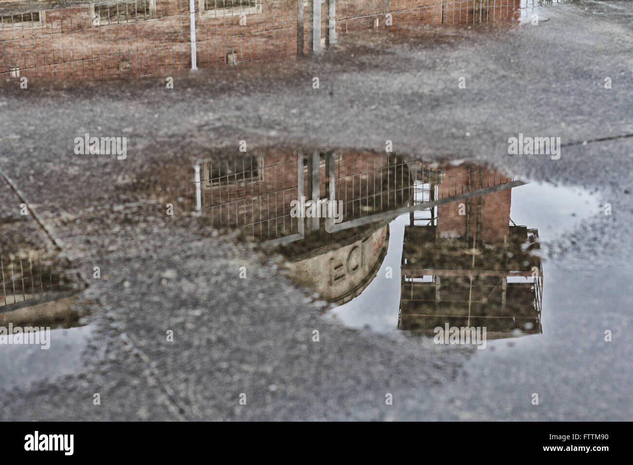 Factory is reflected on a puddle Stock Photo - Alamy