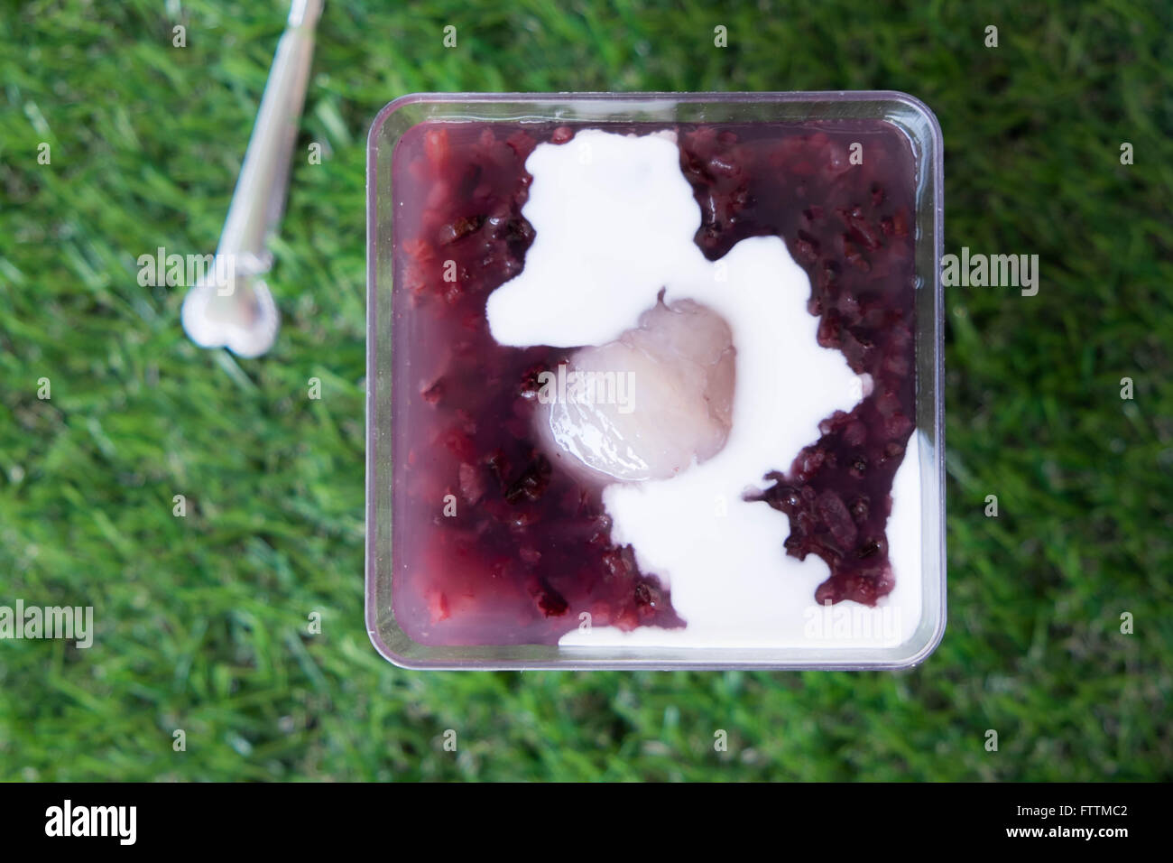 Thai dessert, black sticky rice pudding with longan and coconut cream ...