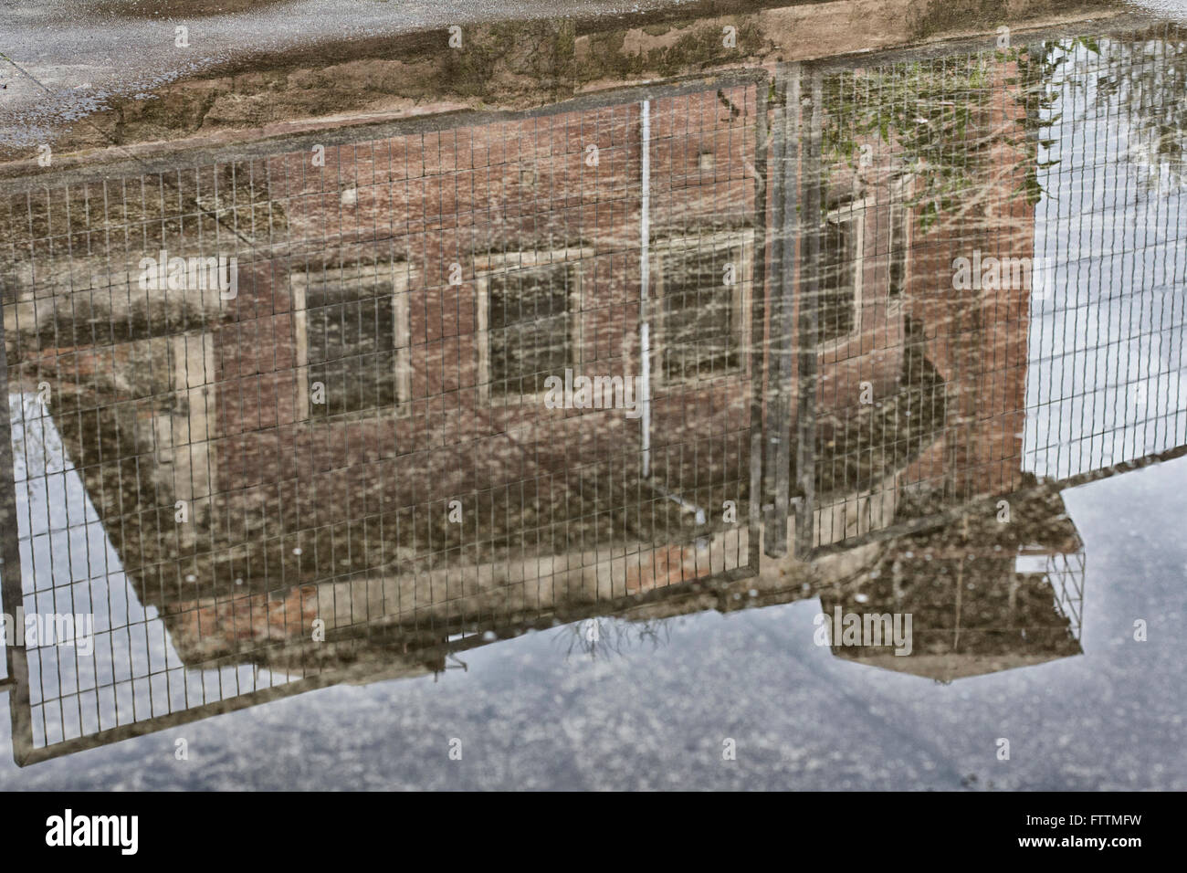 Factory is reflected on a puddle Stock Photo - Alamy