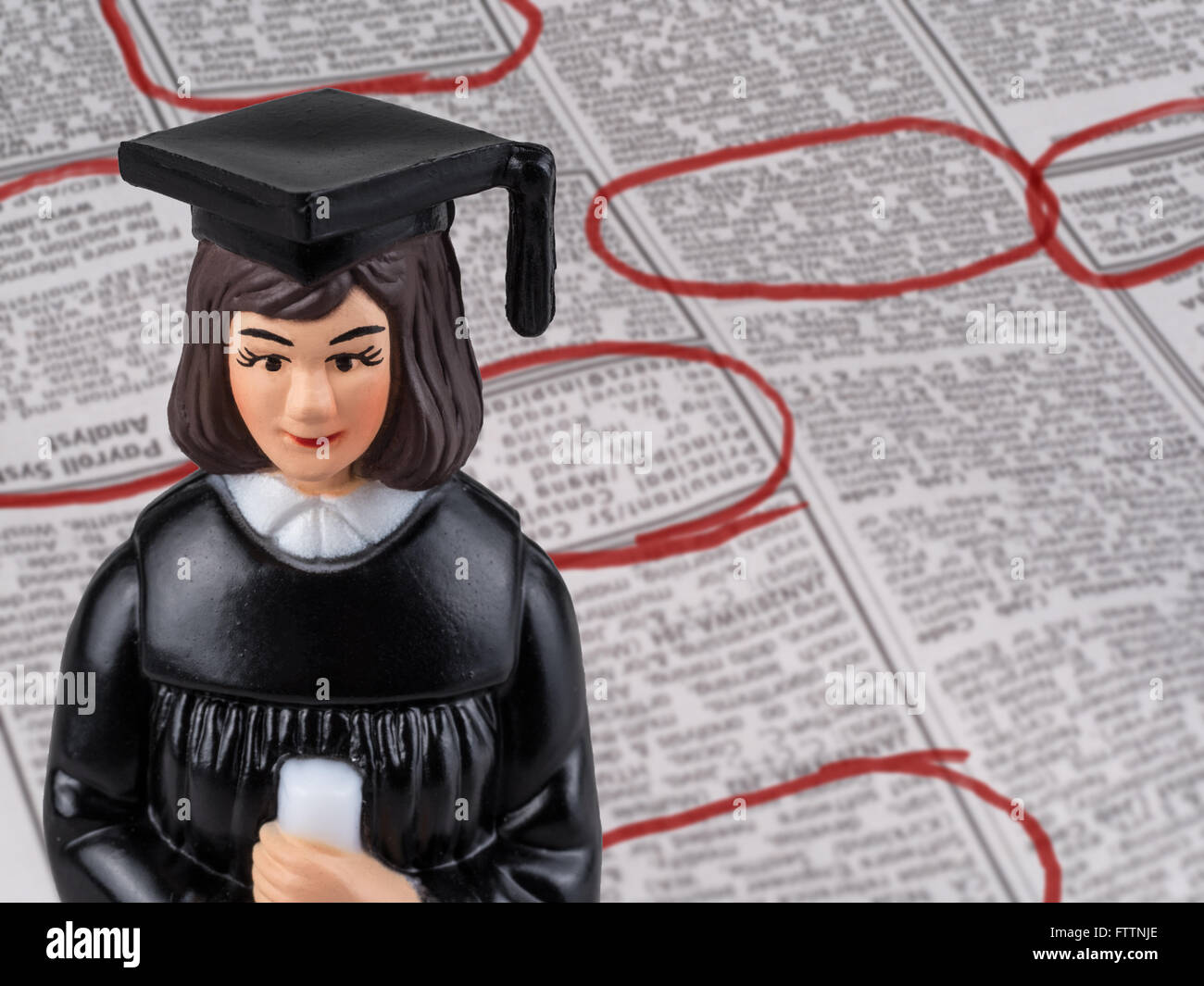 Photograph of a female graduate figurine in cap and gown holding a ...
