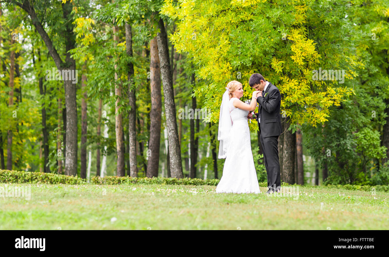 Beautiful Romantic Wedding Couple Kissing and Embracing Outdoors Stock ...