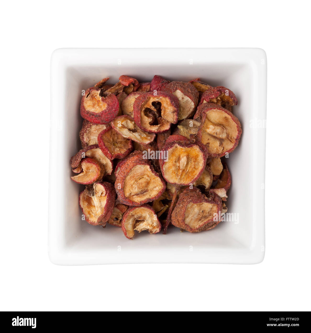 Dried hawthorn fruits in a square bowl isolated on white background ...