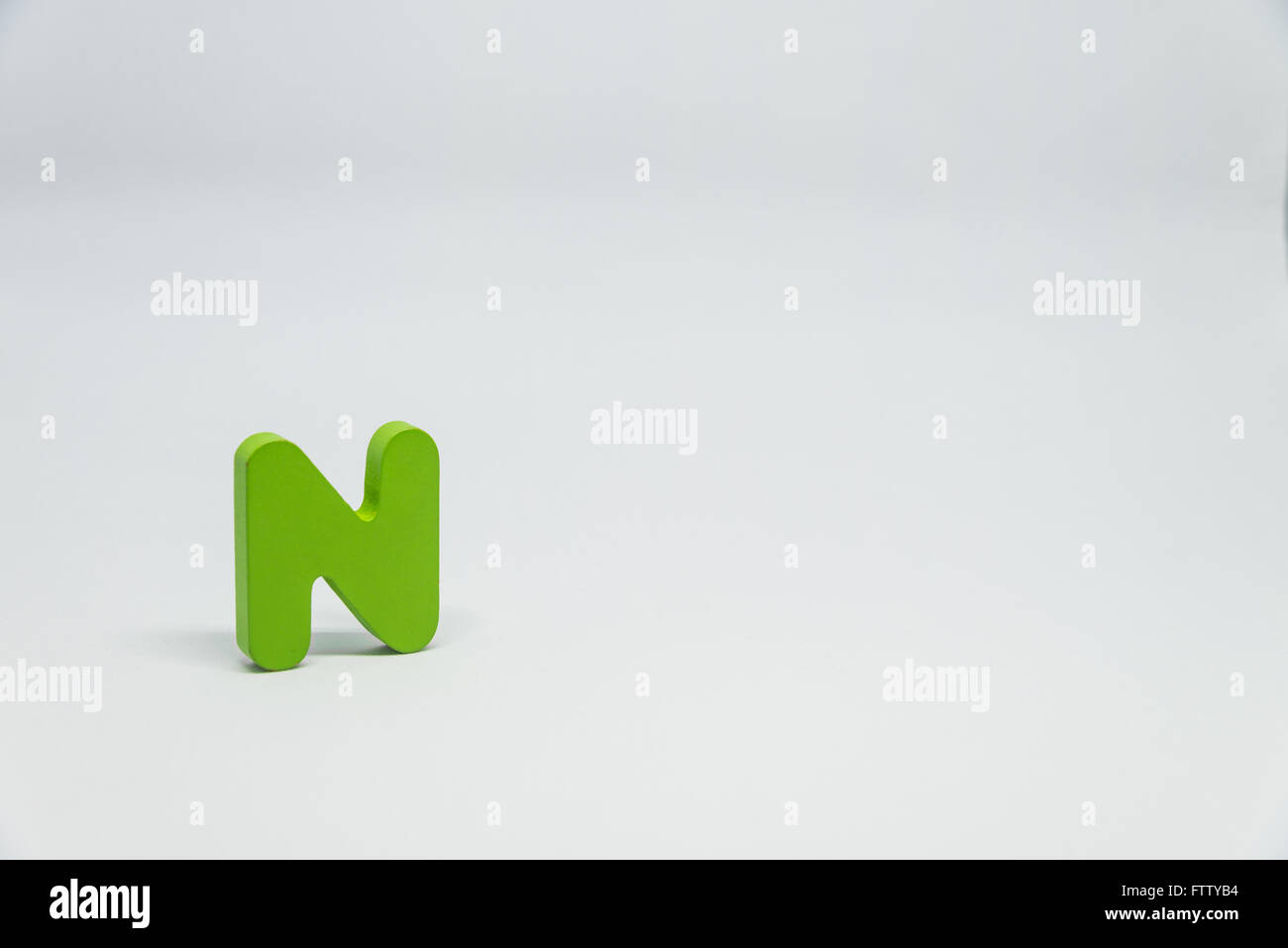 Green Wooden alphabet N with white background Stock Photo - Alamy