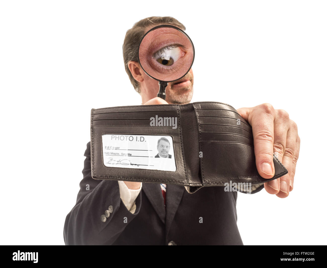Photograph of a man in business attire looking into his wallet with a ...
