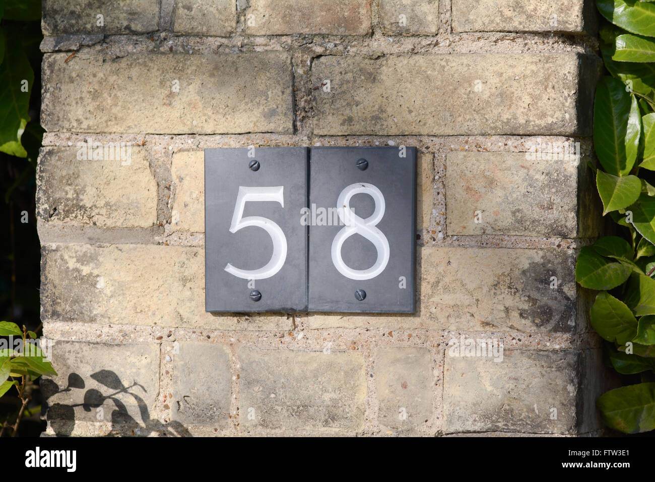 House number 58 sign on wall Stock Photo - Alamy