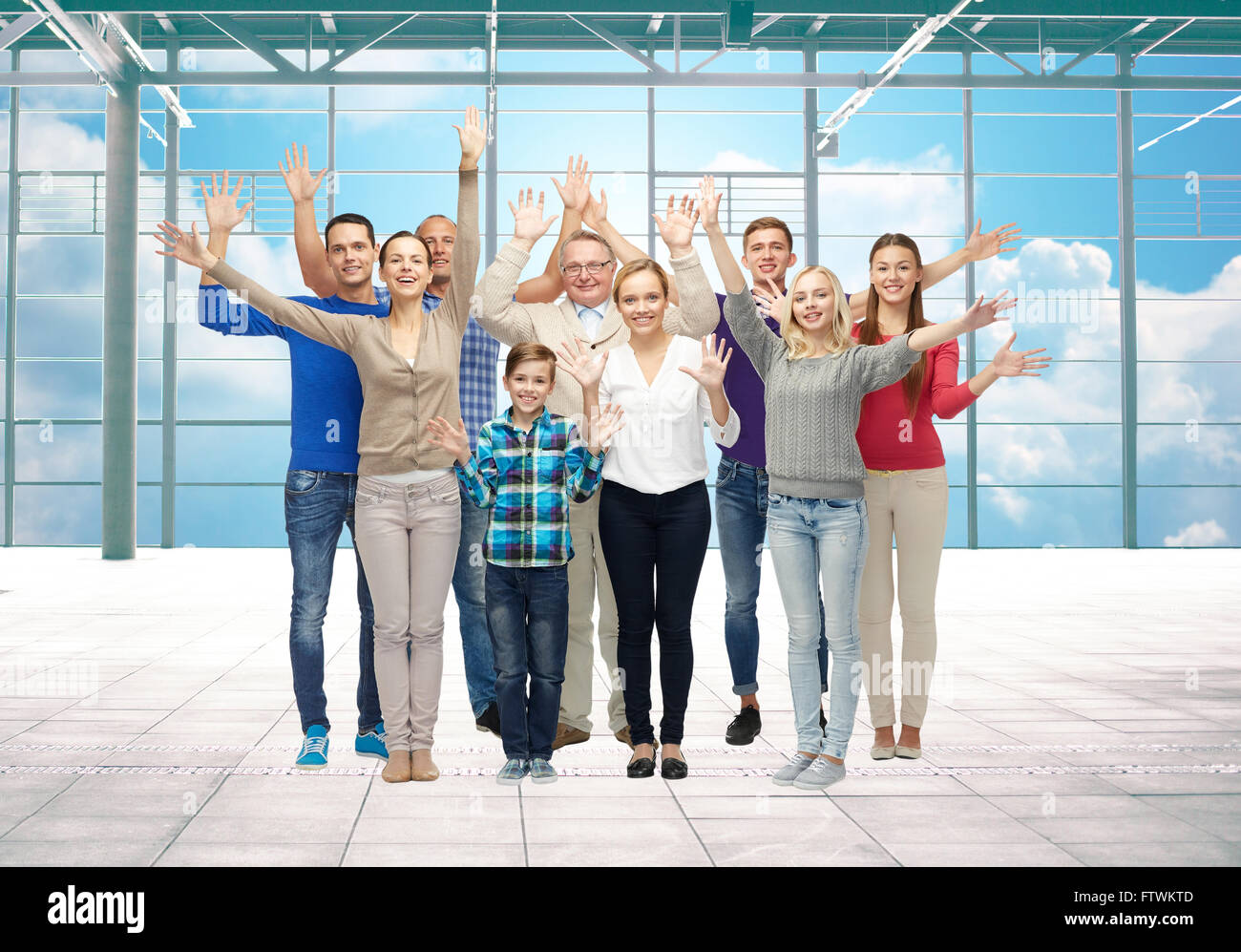 group of smiling people waving hands Stock Photo - Alamy