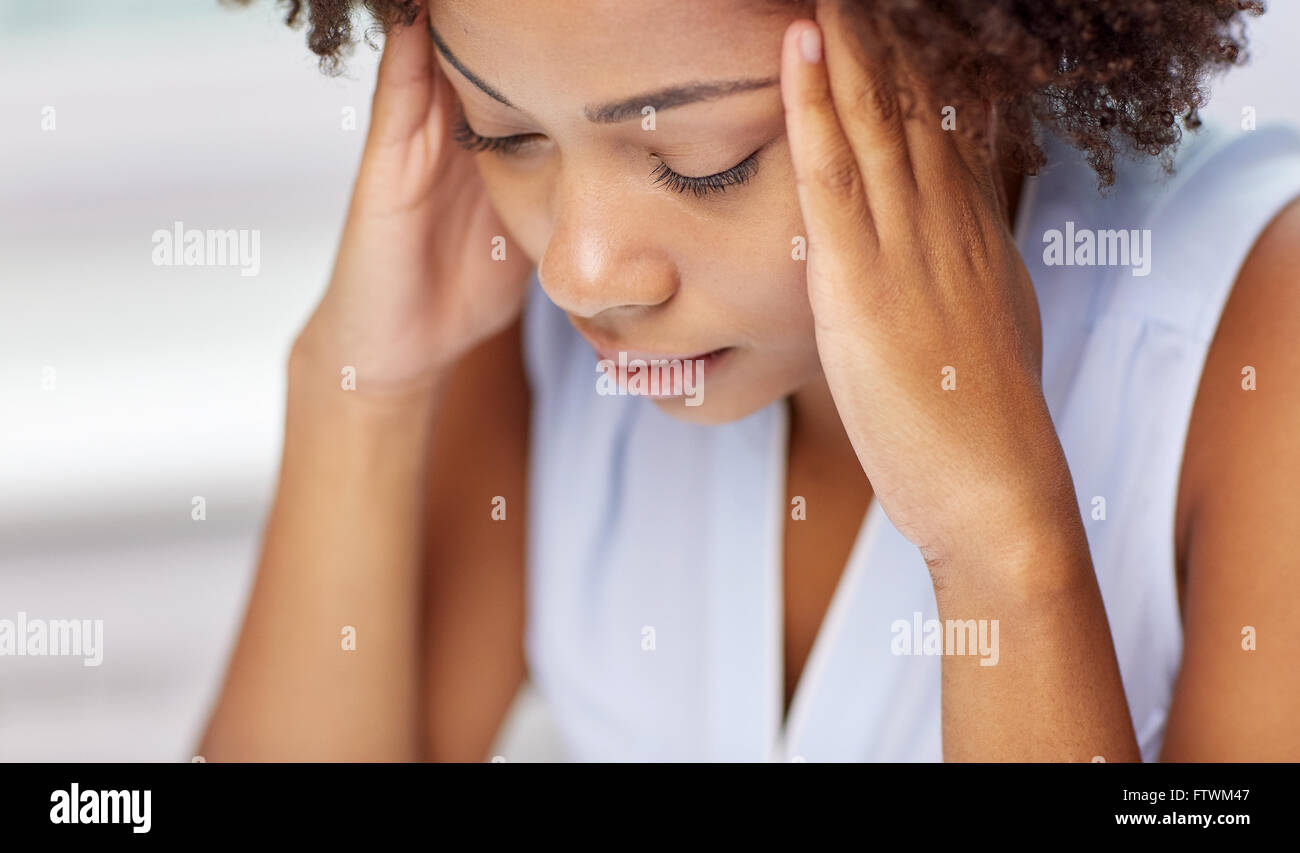 close up of african young woman touching her head Stock Photo - Alamy