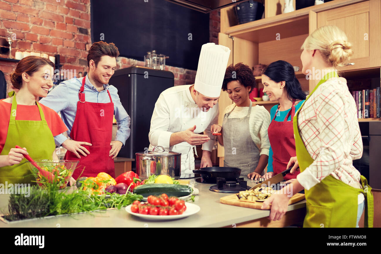 happy friends and chef cook cooking in kitchen Stock Photo - Alamy