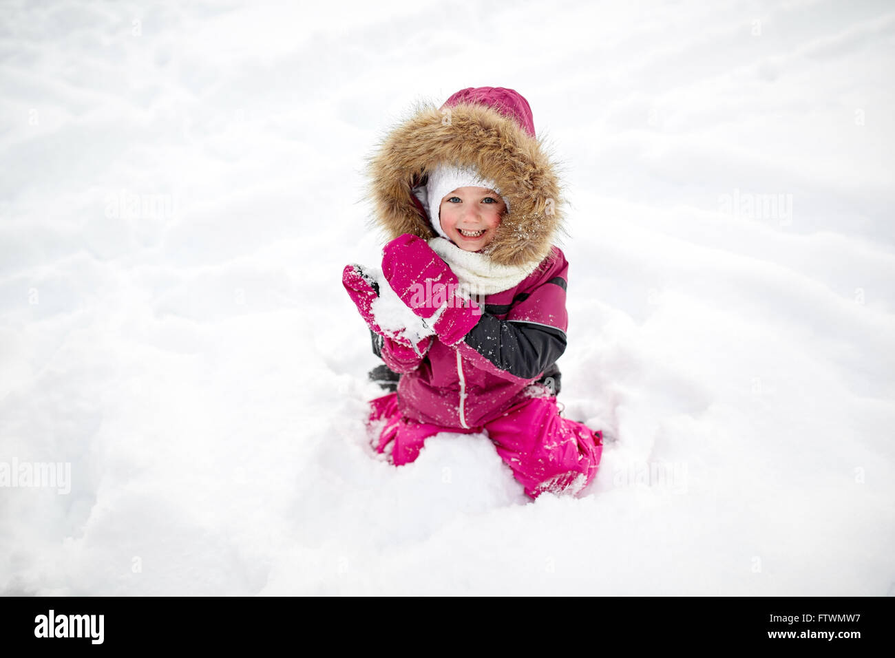f happy little child or girl with snow in winter Stock Photo - Alamy
