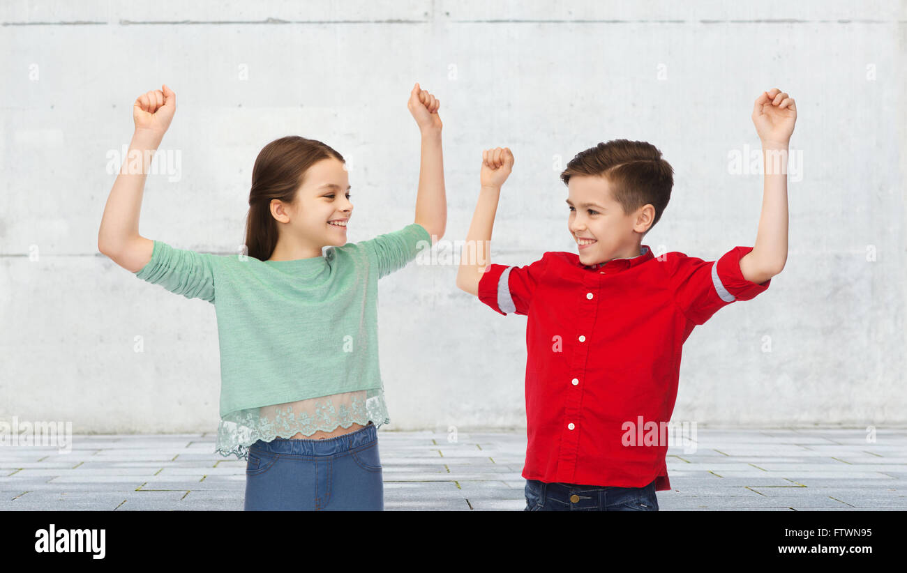 happy boy and girl celebrating victory Stock Photo - Alamy
