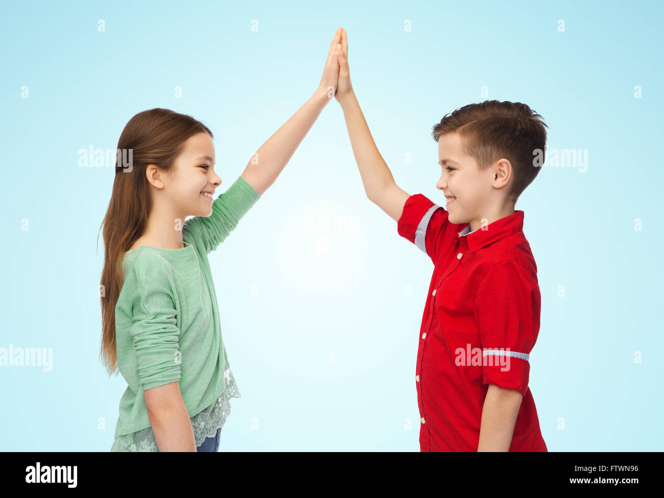 happy boy and girl making high five Stock Photo - Alamy